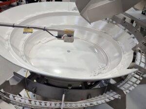 Vibratory bowl feeder to feed and orientate Pistons - RNA Automation