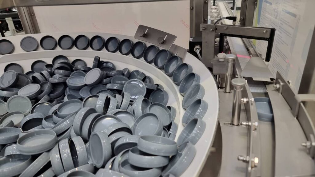 Bowl feeders to feed and orientate Moulding Plastic Caps - RNA Automation